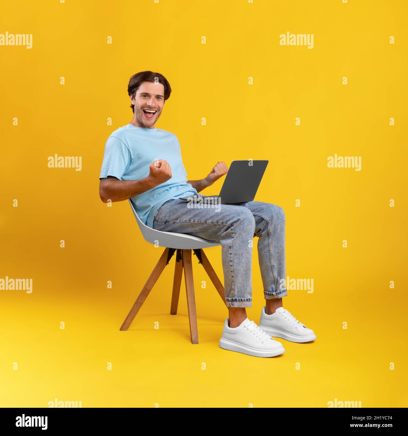 Excited guy using pc celebrating success shaking fists Stock Photo - Alamy