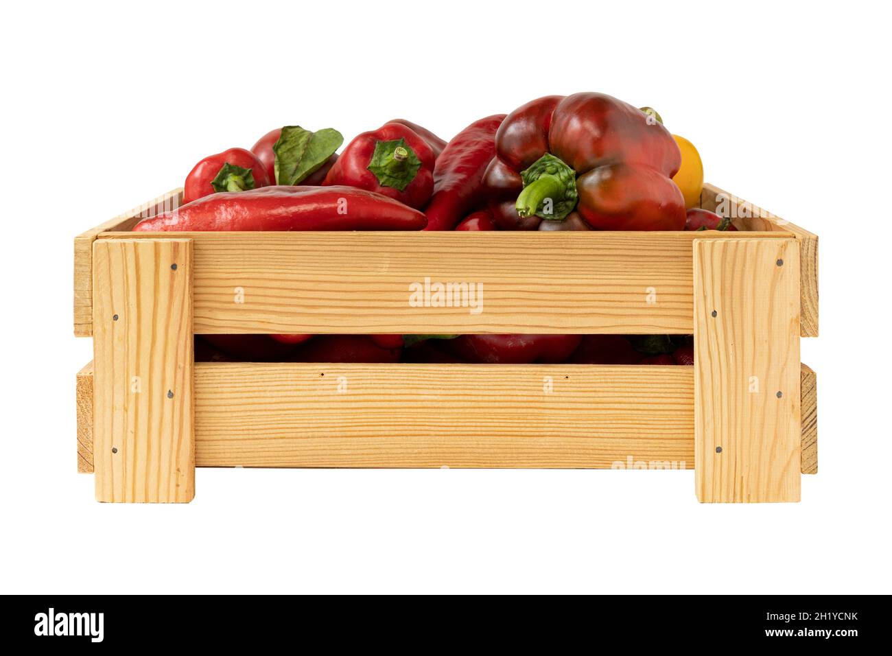 red peppers in wooden crate isolated on white background, fresh sweet ...