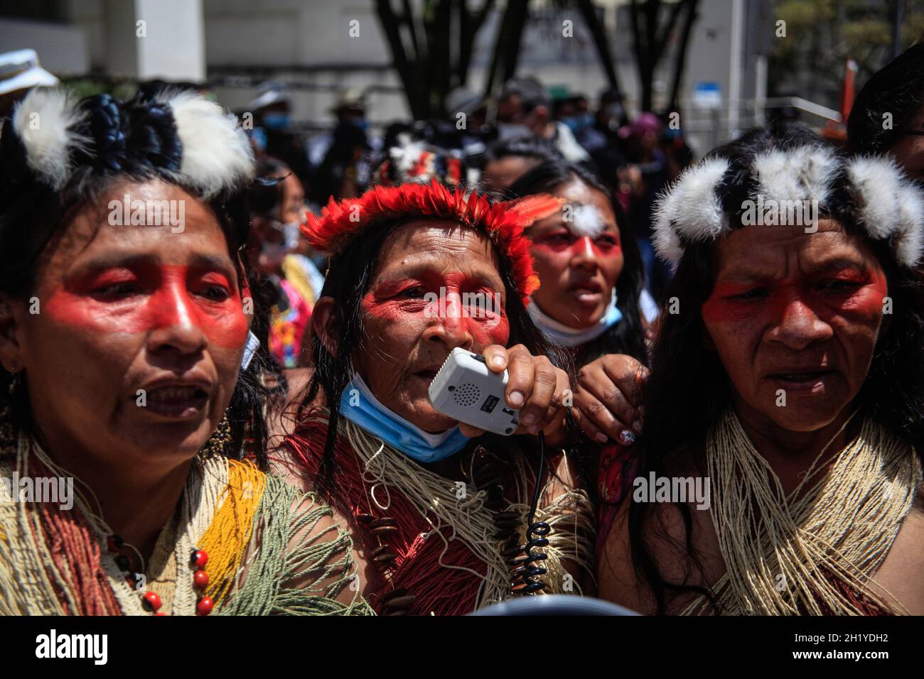 Three Waorani women dance and sing using a megaphone outside the ...