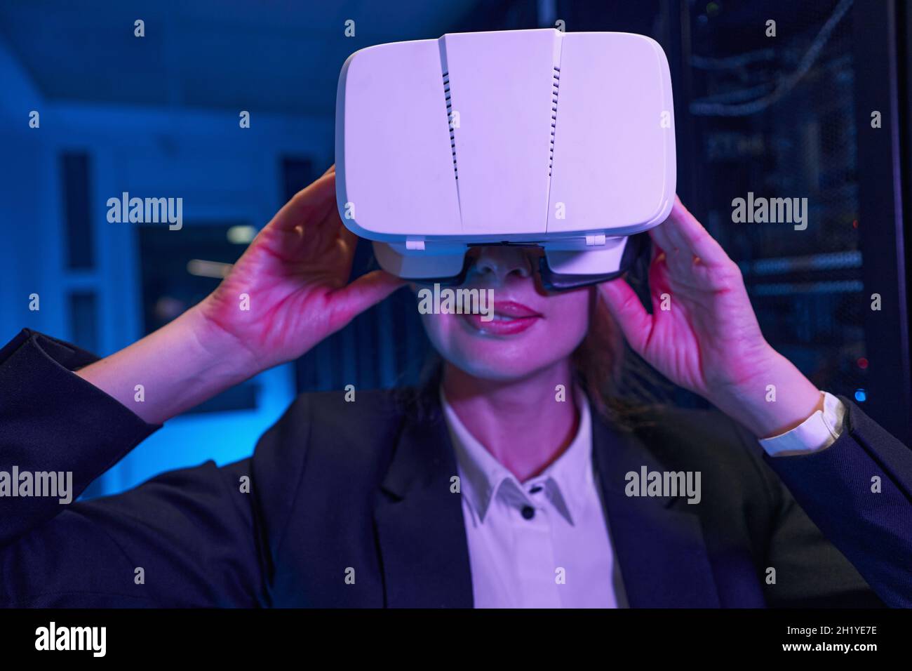 Computer engineer enjoying VR headset in data center Stock Photo - Alamy