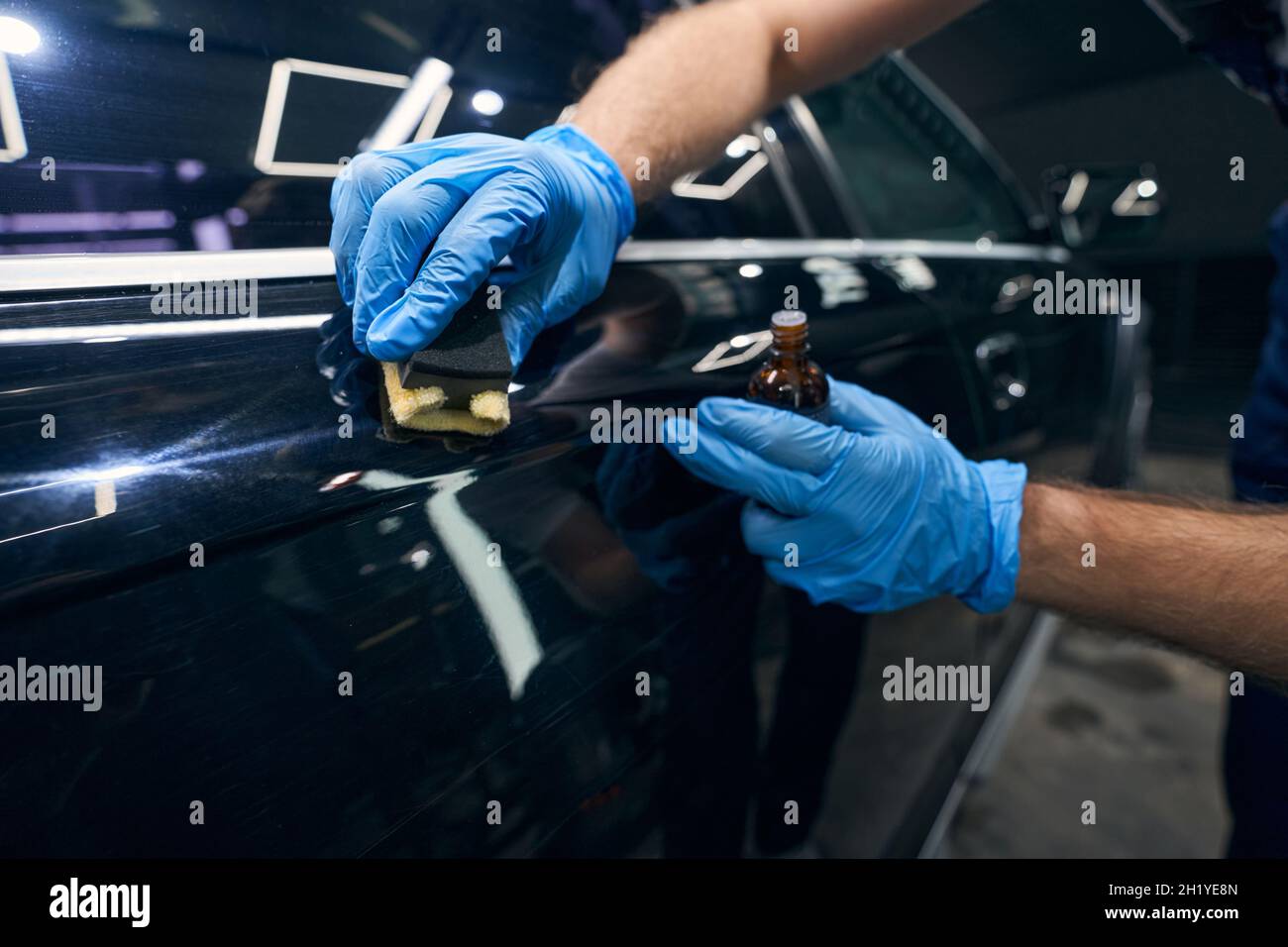 Person applying coating on car surface scratches Stock Photo - Alamy