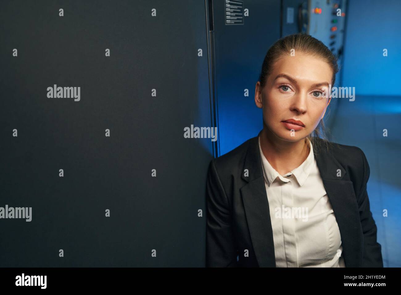 Attractive female network engineer standing in server room Stock Photo ...
