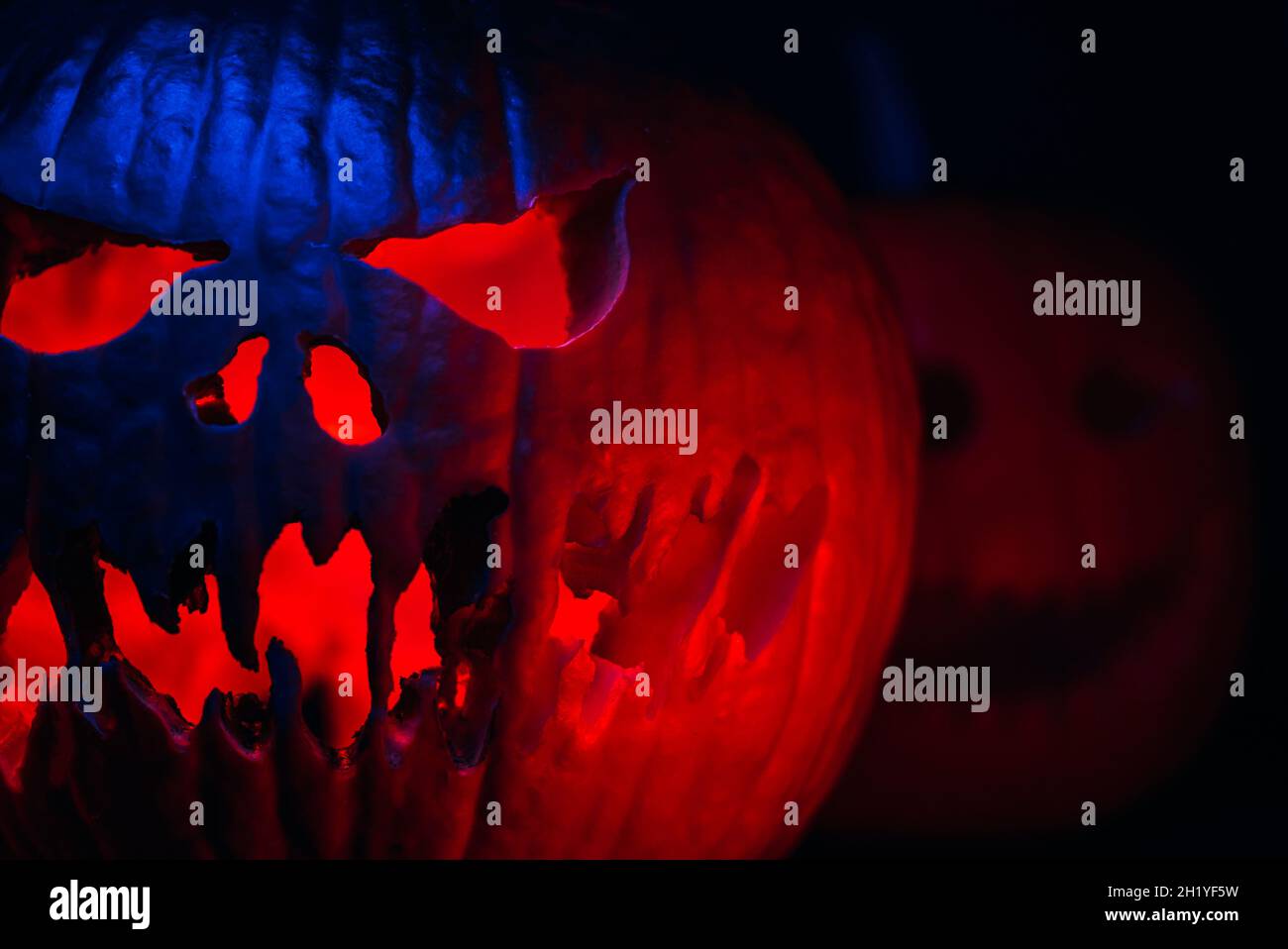 Orange mad pumpkin as head of Jack-o-lantern with carved eyes and ...