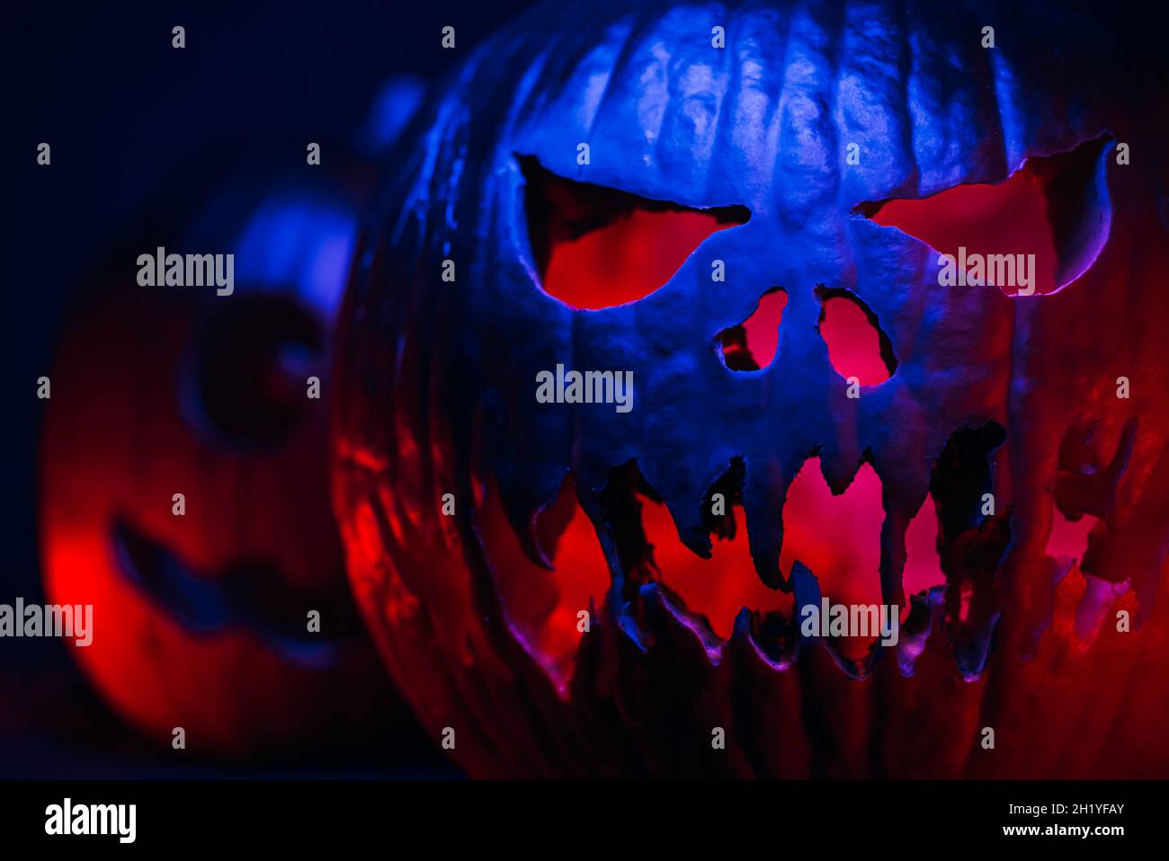 Orange mad pumpkin as head of Jack-o-lantern with carved eyes and ...