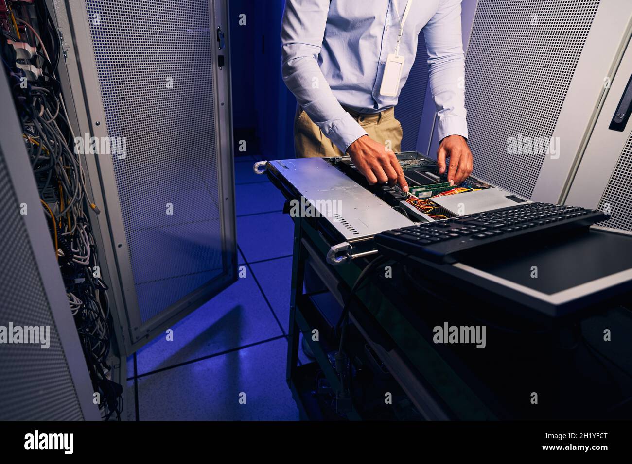 Data center engineer performing hardware replacement procedure Stock ...