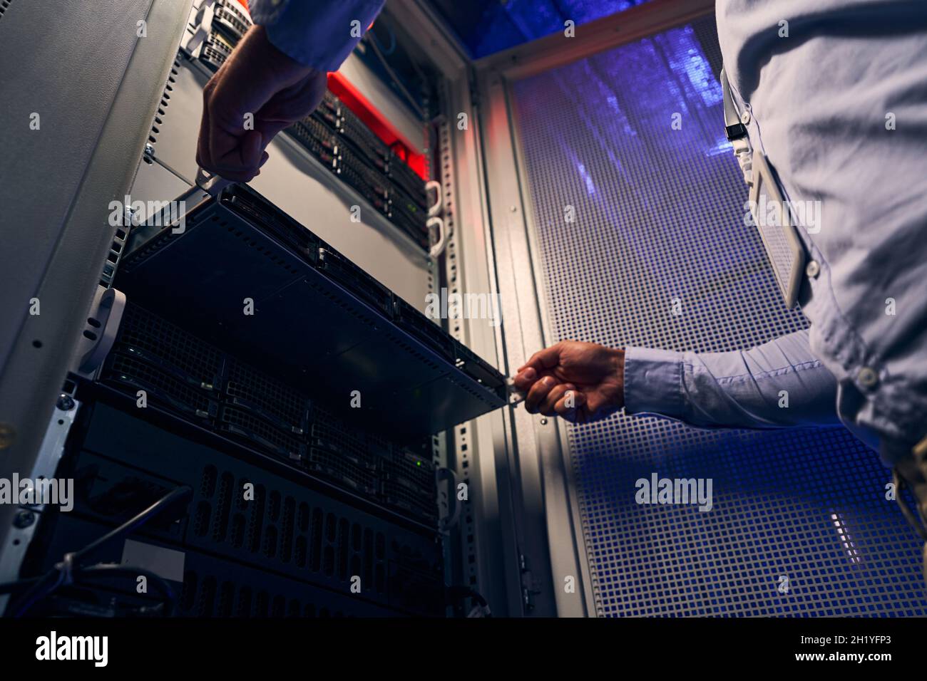 Data center employee upgrading old hardware equipment Stock Photo - Alamy