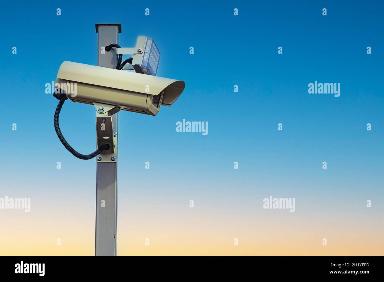 Outdoor surveillance camera against the blue sky. Control and security ...