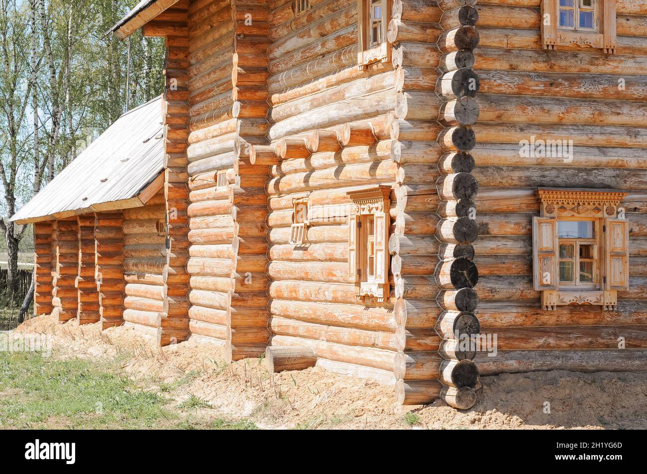 wooden rustic house made of timber and windows with carved shutters in ...