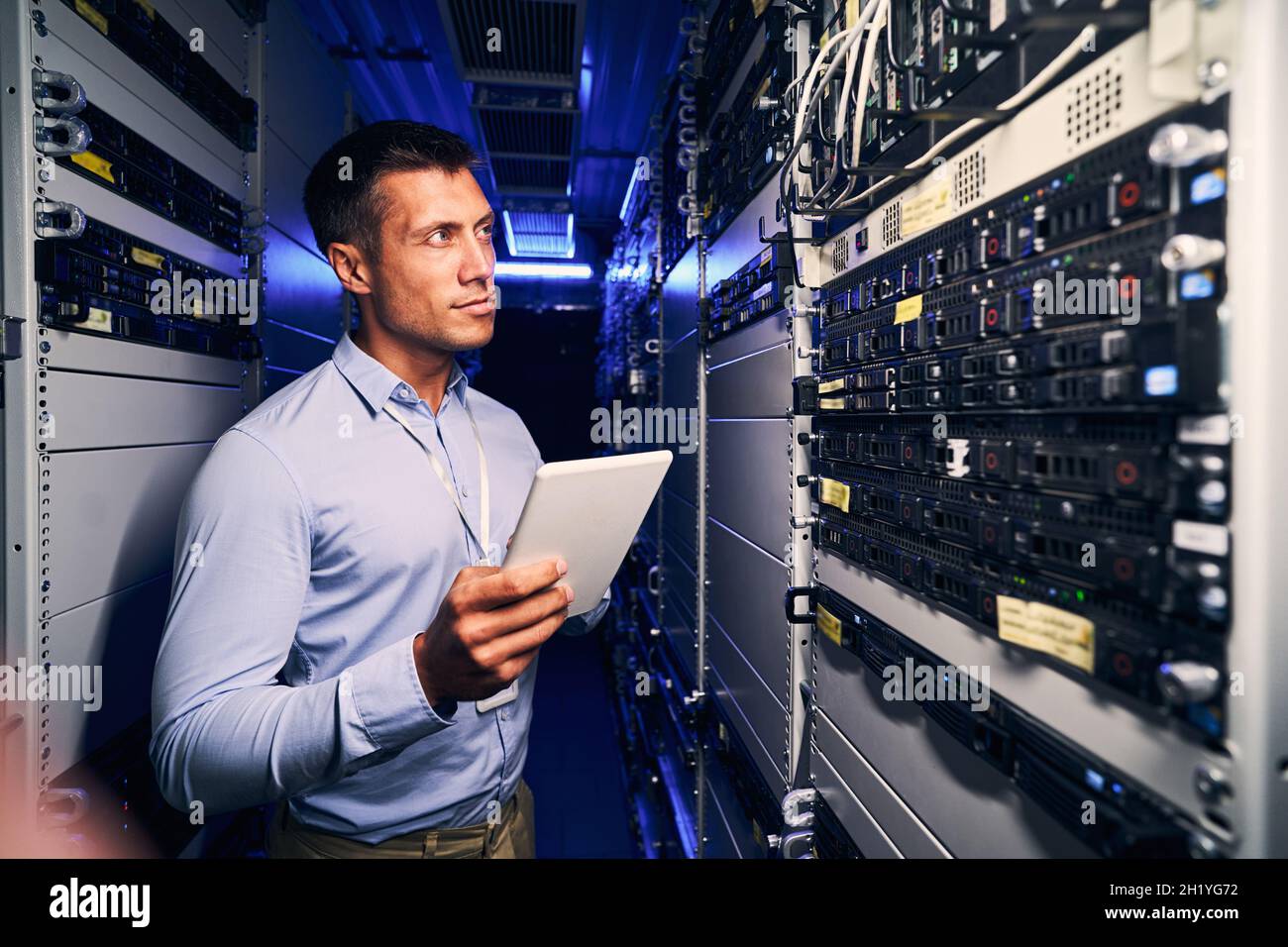 Concentrated tranquil system administrator inspecting networking ...