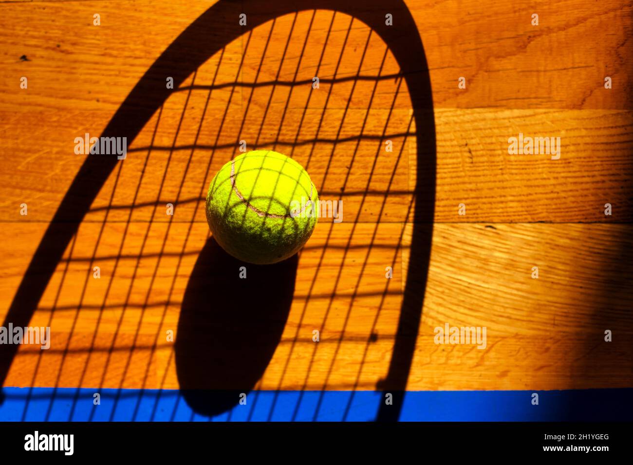 The sight of a tennis ball and the shadow on the floor from a tennis ...