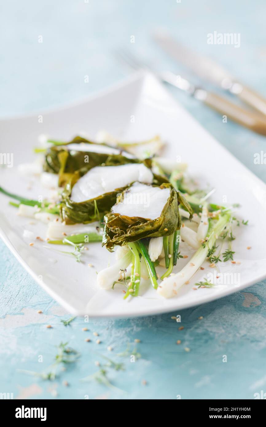 Monkfish wrapped in seaweed bacon Stock Photo - Alamy