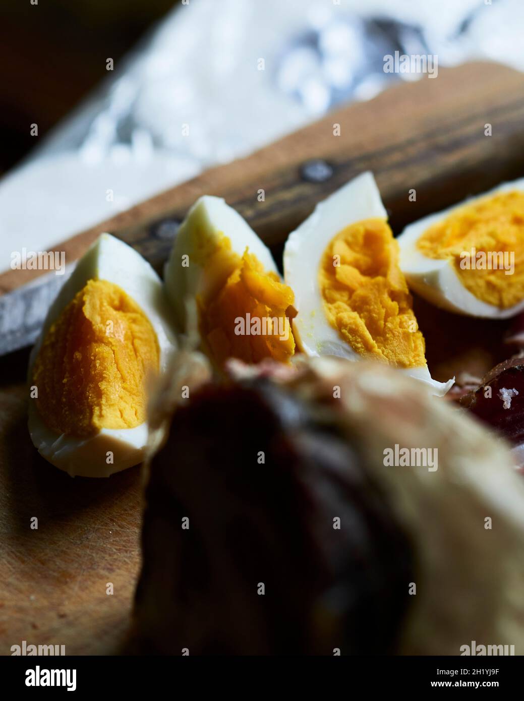 Hard-boiled eggs in wedges on a wooden board Stock Photo - Alamy