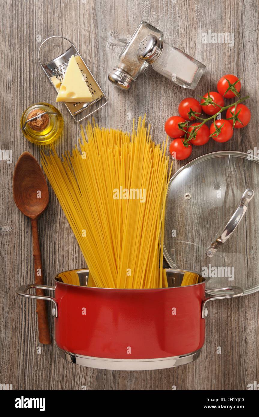Ingredients and cooking utensils for a pasta dish (seen from above ...