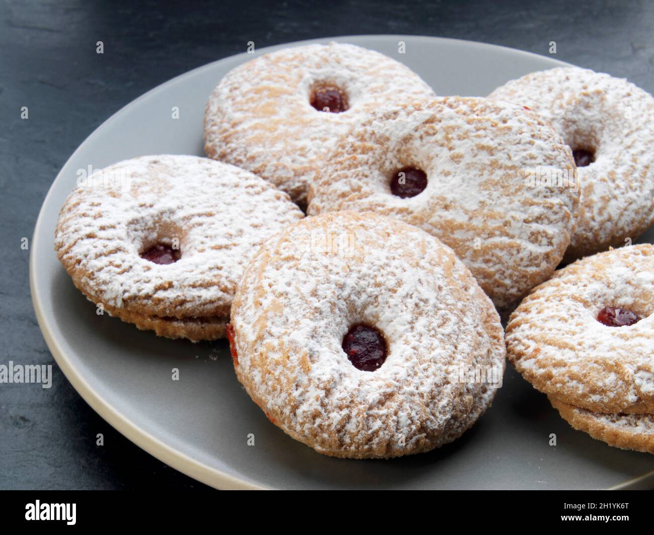 Raspberry-filled biscuits dusted with icing sugar Stock Photo - Alamy