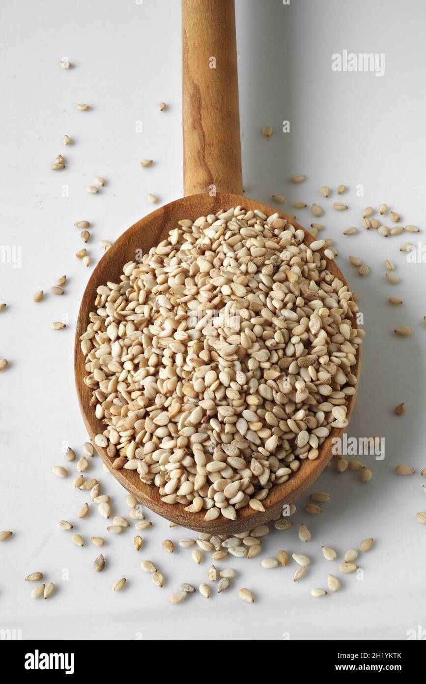 Sesame seeds on an olive wood spoon Stock Photo - Alamy