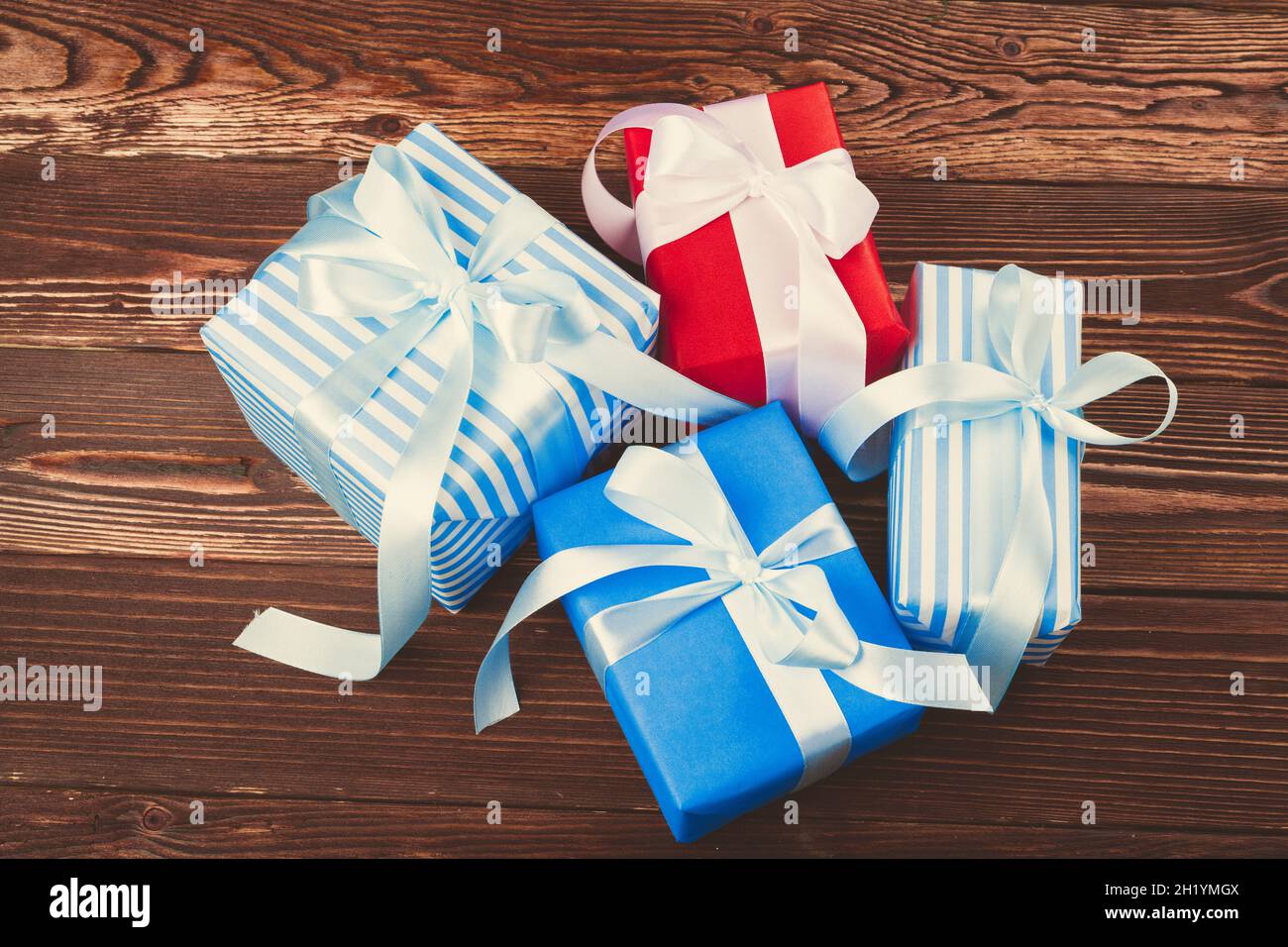 Brown wooden table with decorated gift boxes Stock Photo - Alamy