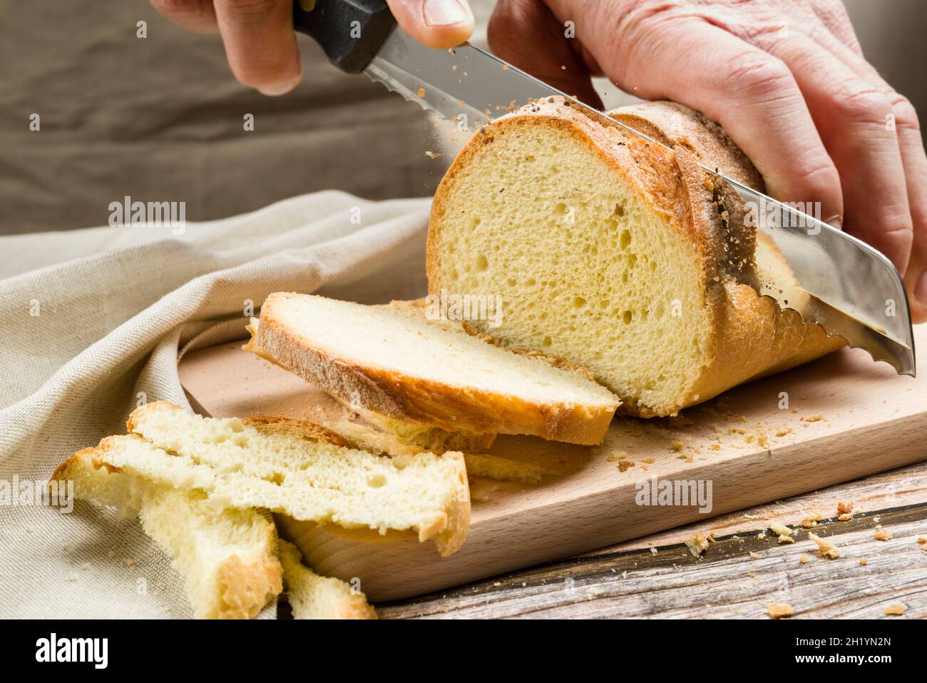 Whole grain bread on kitchen table with knife for cut Stock Photo - Alamy