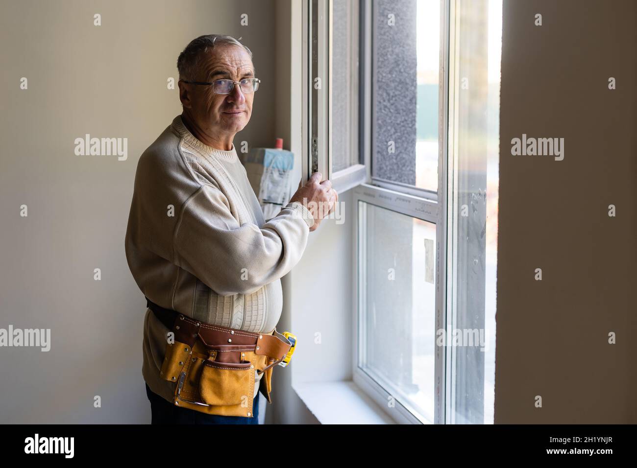 Windows installation worker. window customizer Stock Photo - Alamy