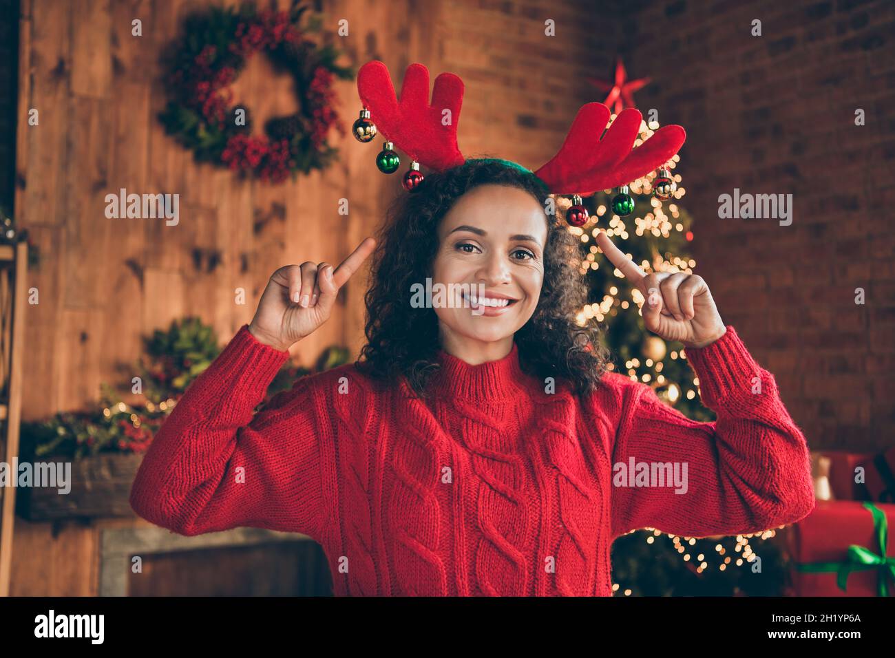 Photo of pretty shiny mature woman wear red sweater smiling pointing ...