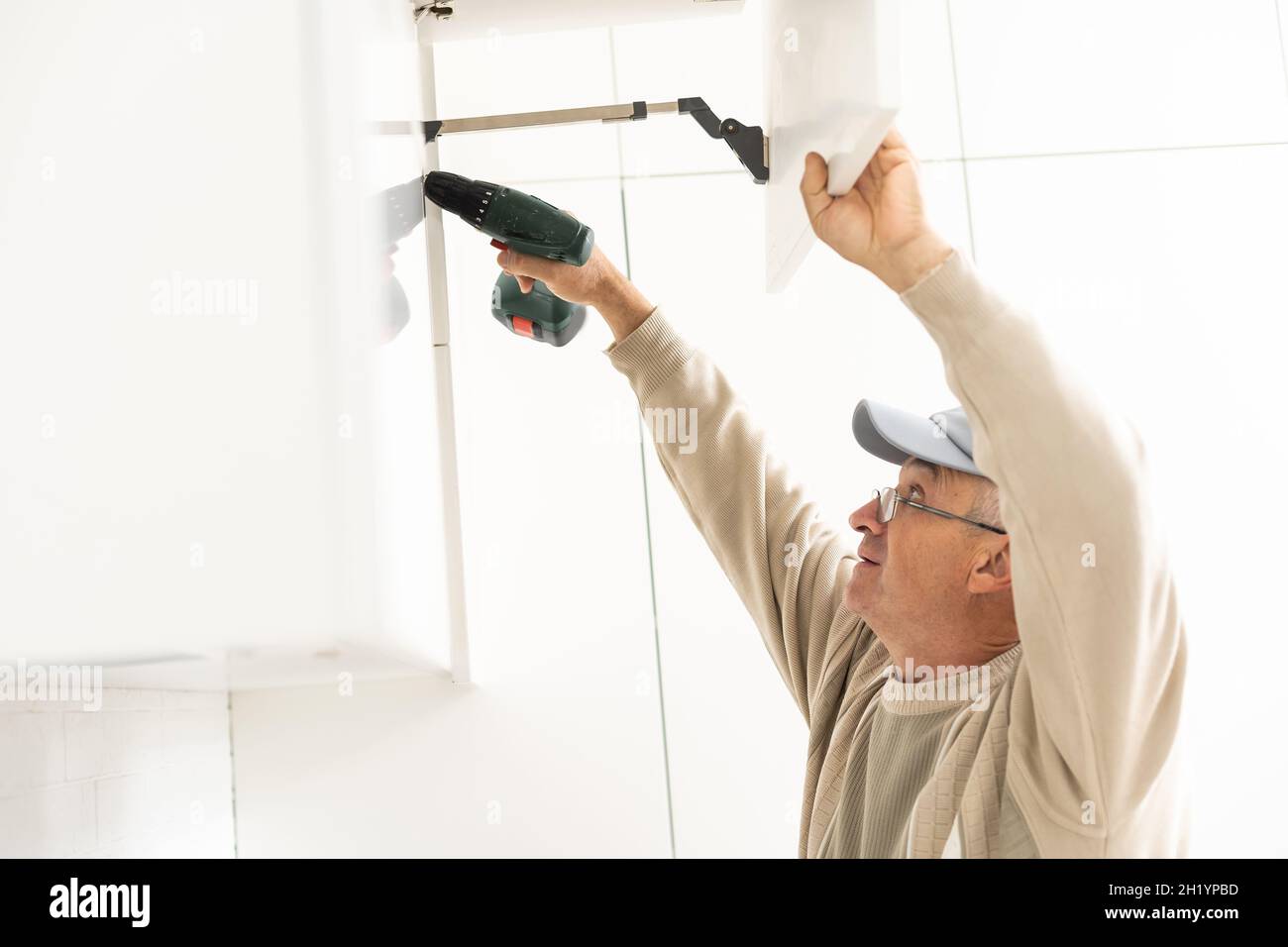 Mature Male Serviceman Repairing With Toolbox In Kitchen Stock Photo ...