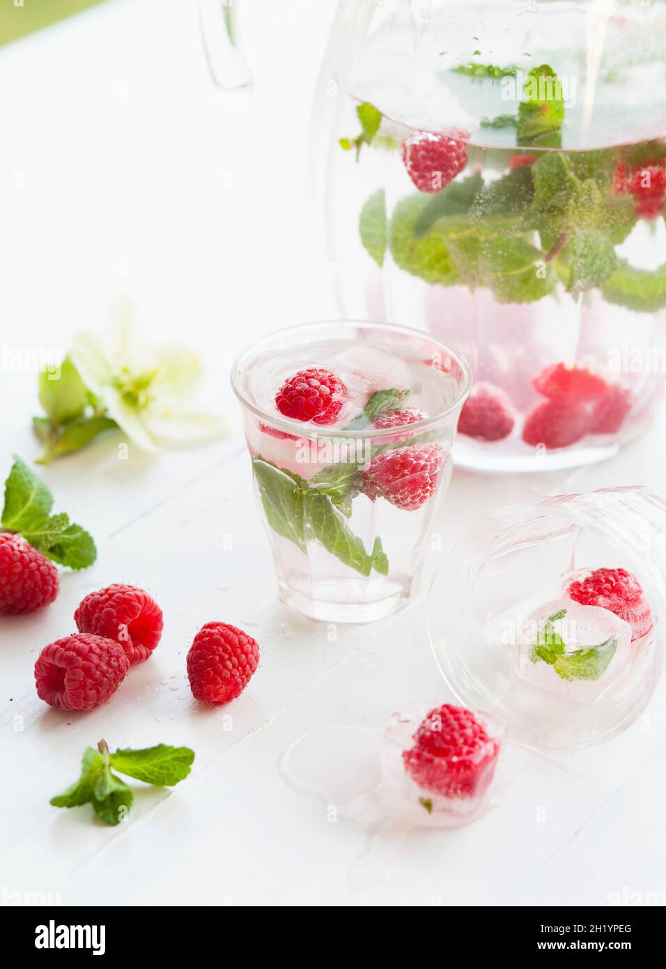 Water flavoured with raspberries, mint and ice cube Stock Photo - Alamy