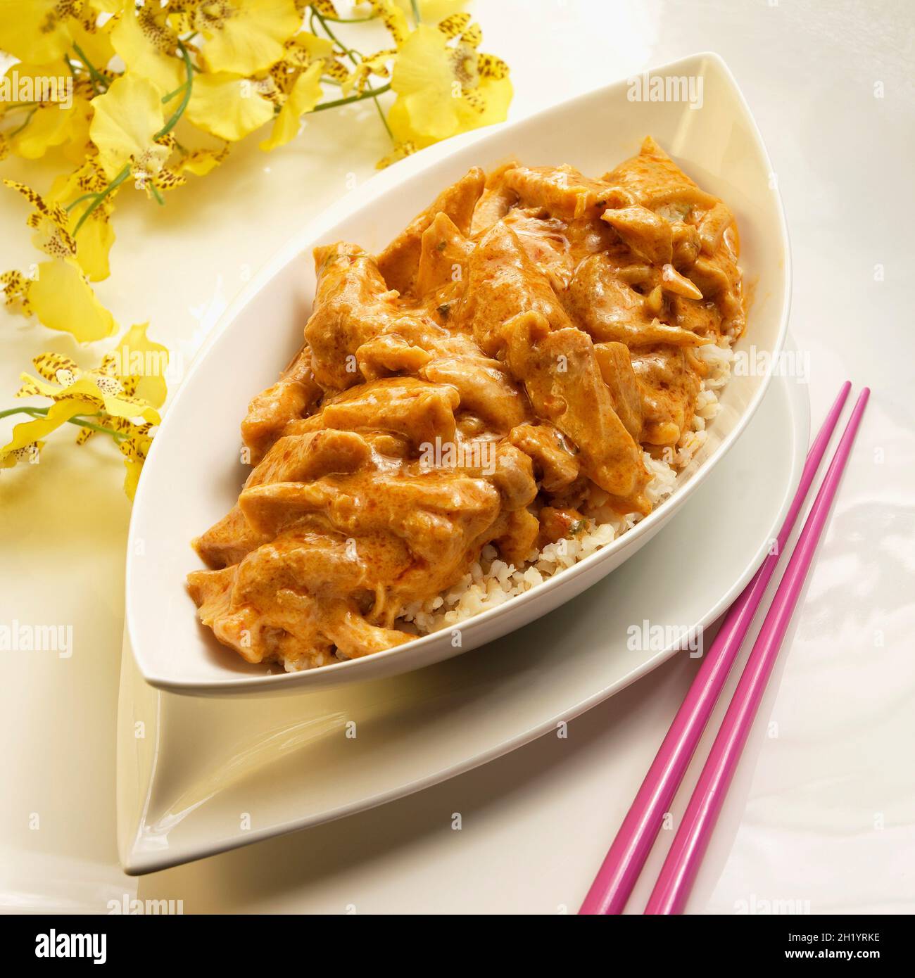 Red chicken curry on rice with chop sticks Stock Photo - Alamy
