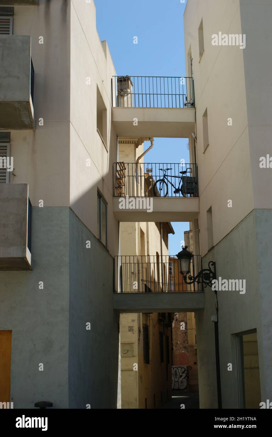 Vertical of a corridor surrounded by apartment buildings with balconies ...