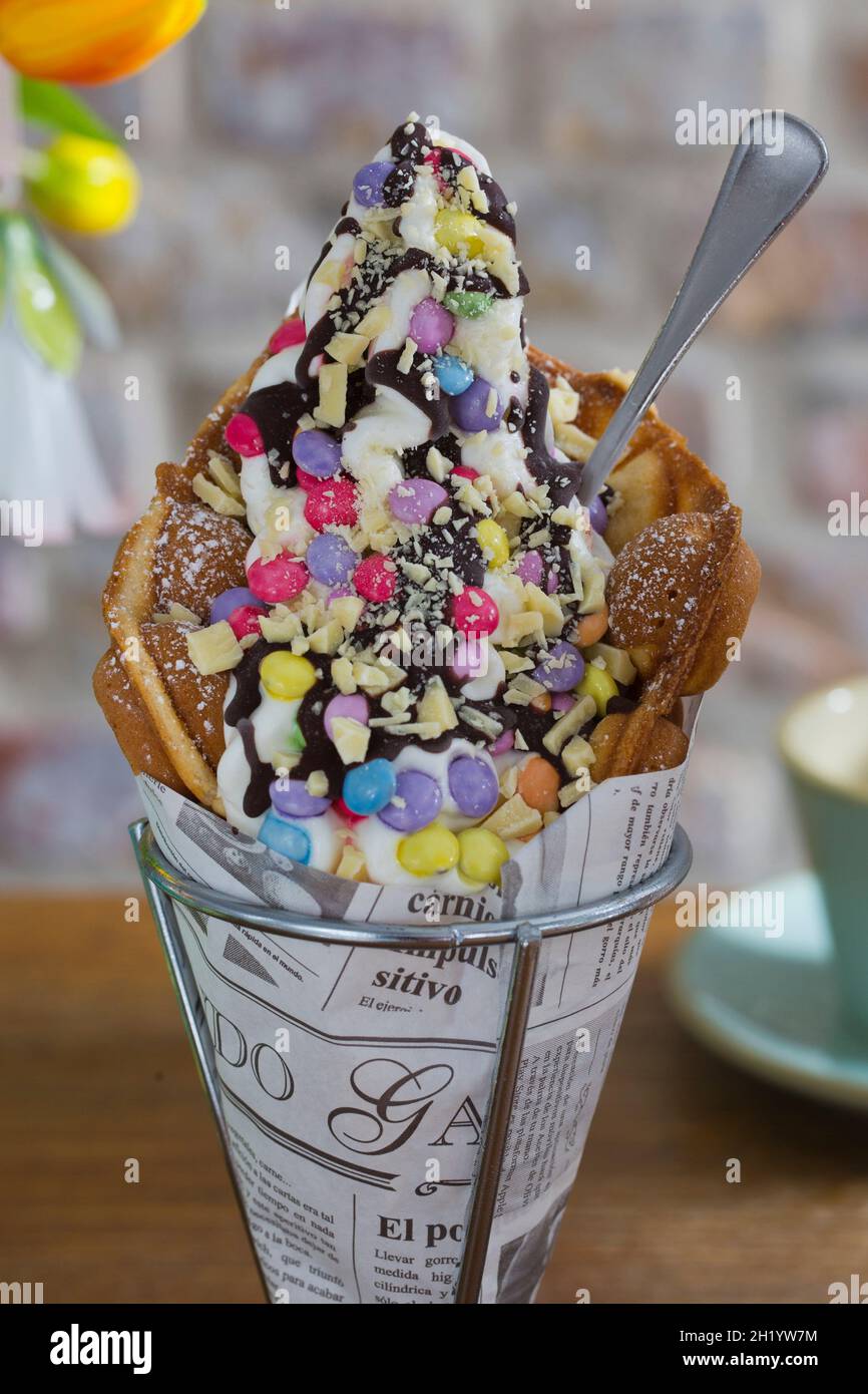 A bubble waffle with cream, Smarties, white chocolate and chocolate ...