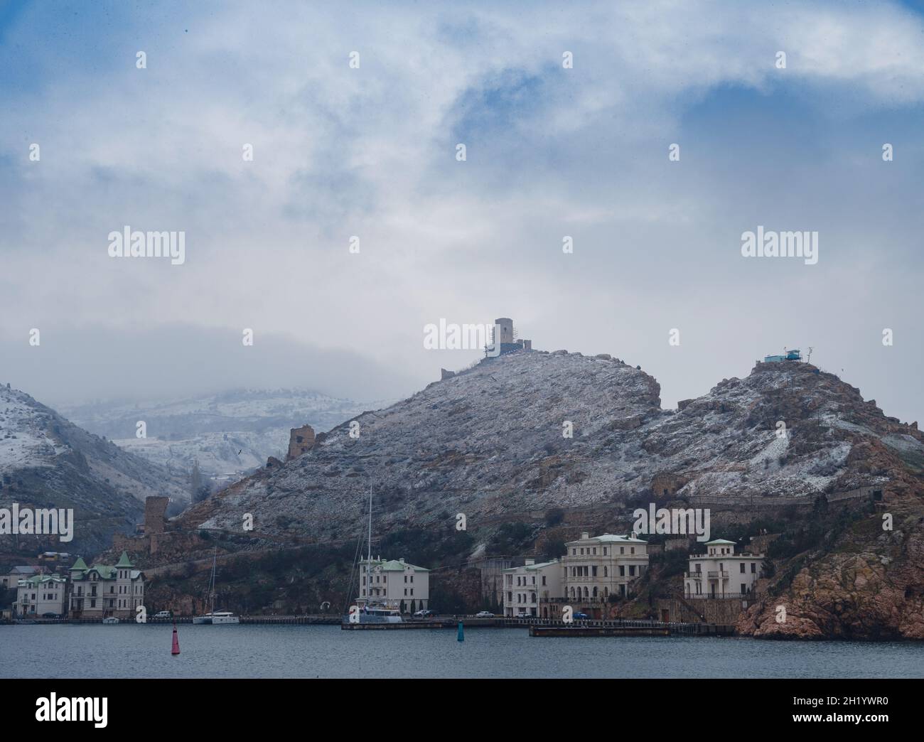 ancient castle ruins on a beautiful rock rise above the sea. winter ...