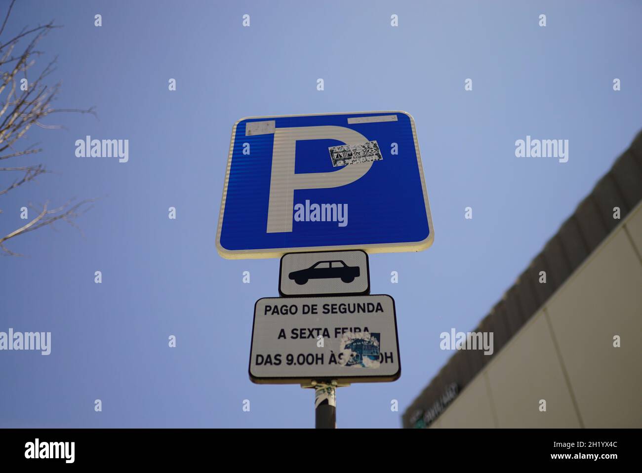 Low angle of a metallic blue parking sign on the side of the road Stock ...