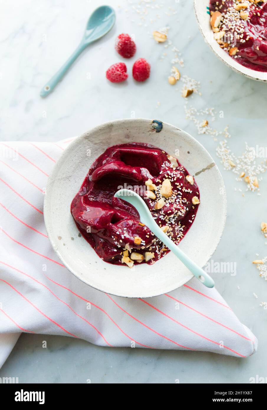 An acai bowl with puffed amaranth and roasted nuts (seen from above ...