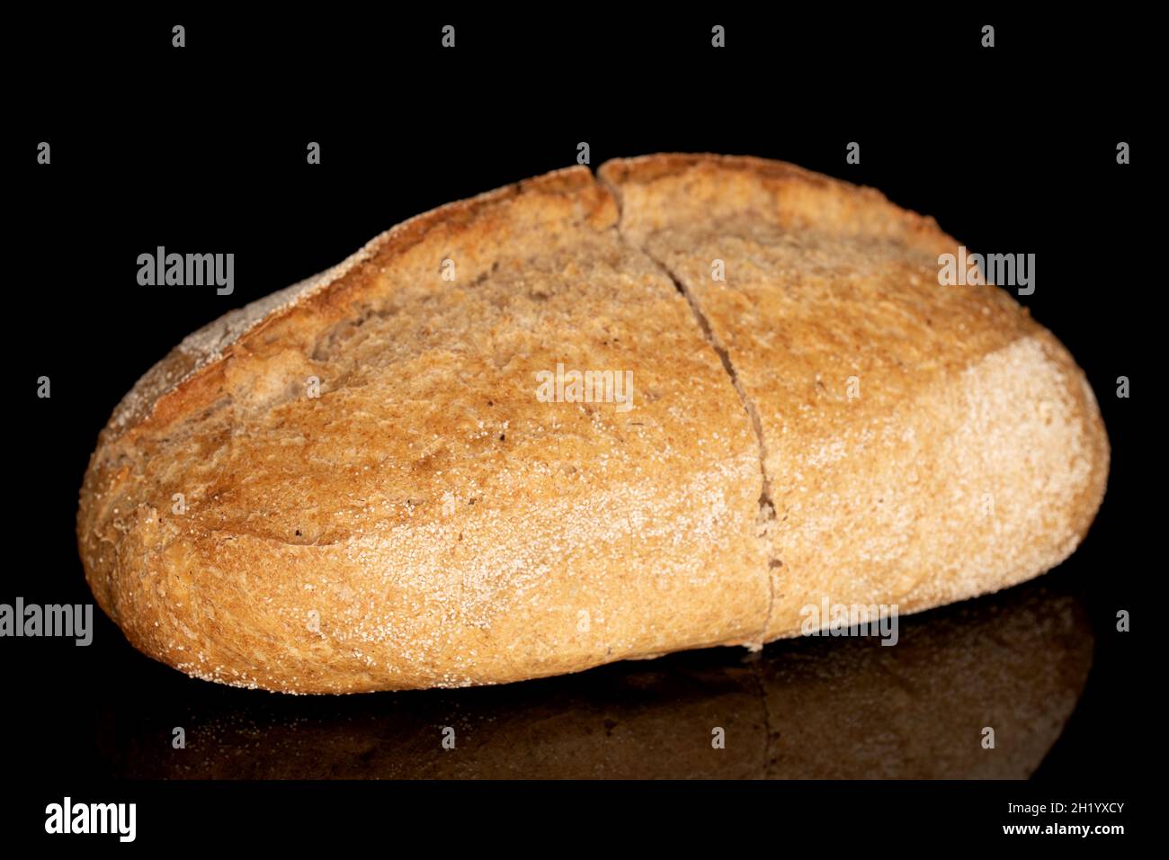 One loaf without yeast with bran flakes, close-up, isolated on black ...