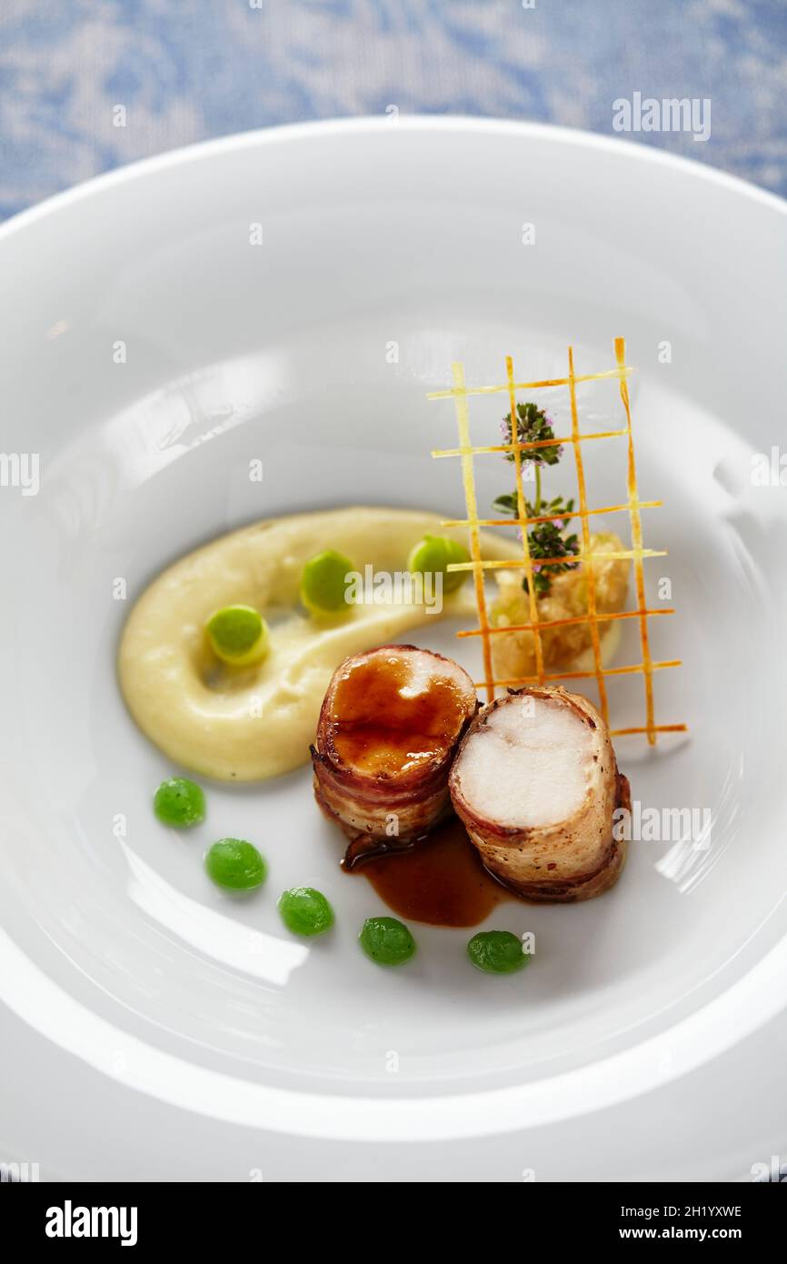 Rabbit wrapped in bacon with green apple and horseradish sauce Stock ...