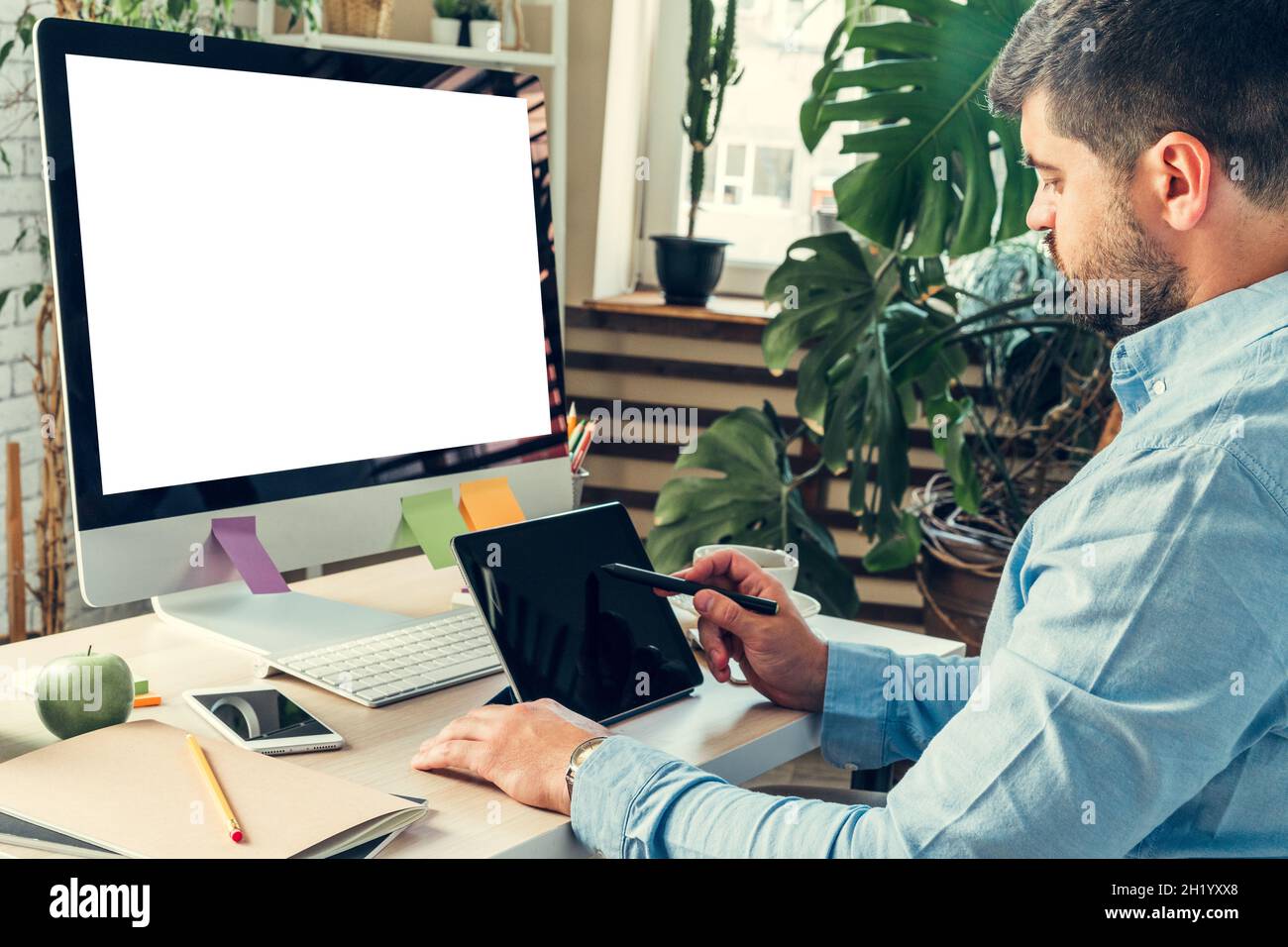 Office worker doing his job sitting at his working table with a ...