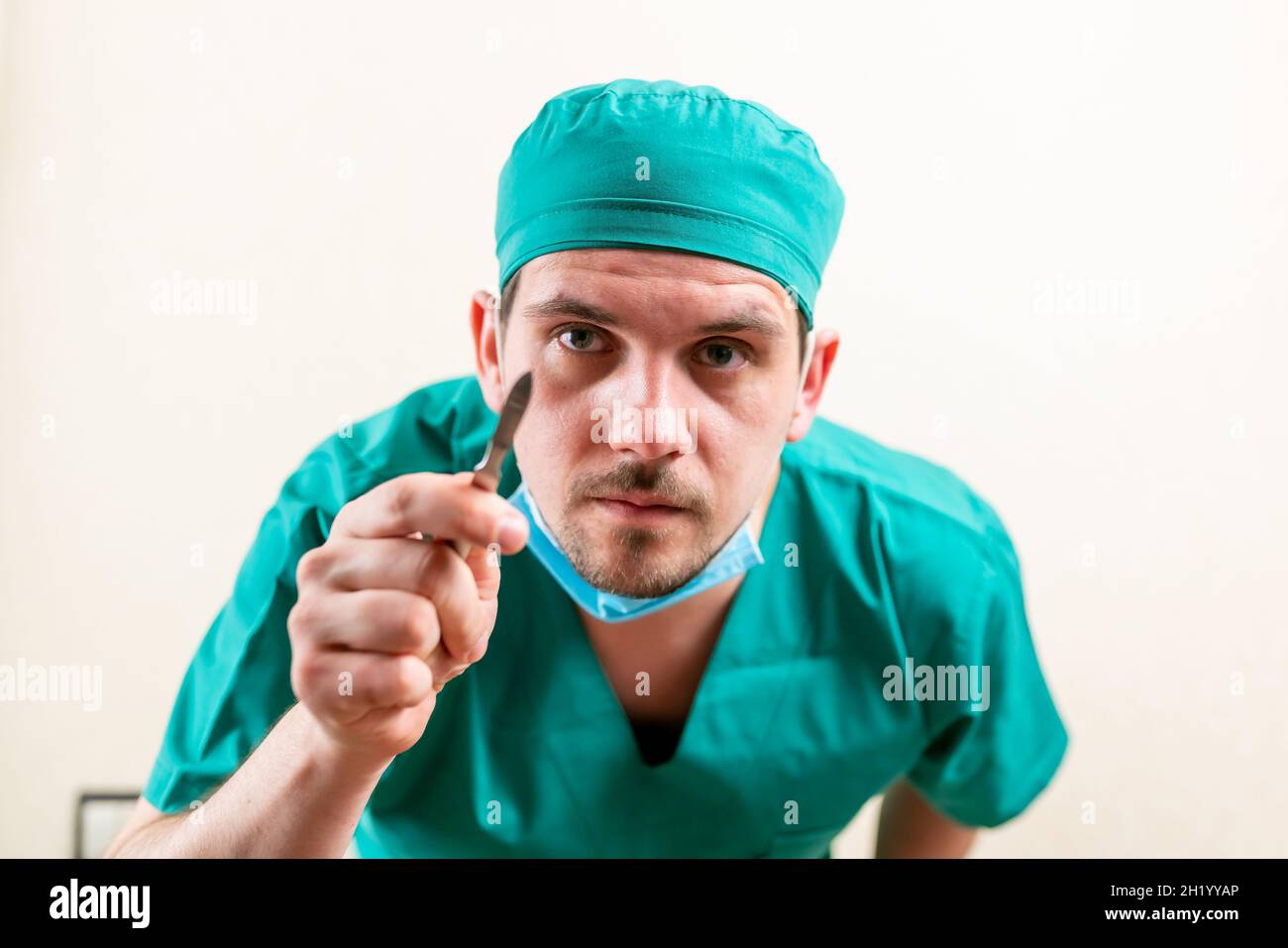 Funny doctor with a scalpel in his hands Stock Photo - Alamy