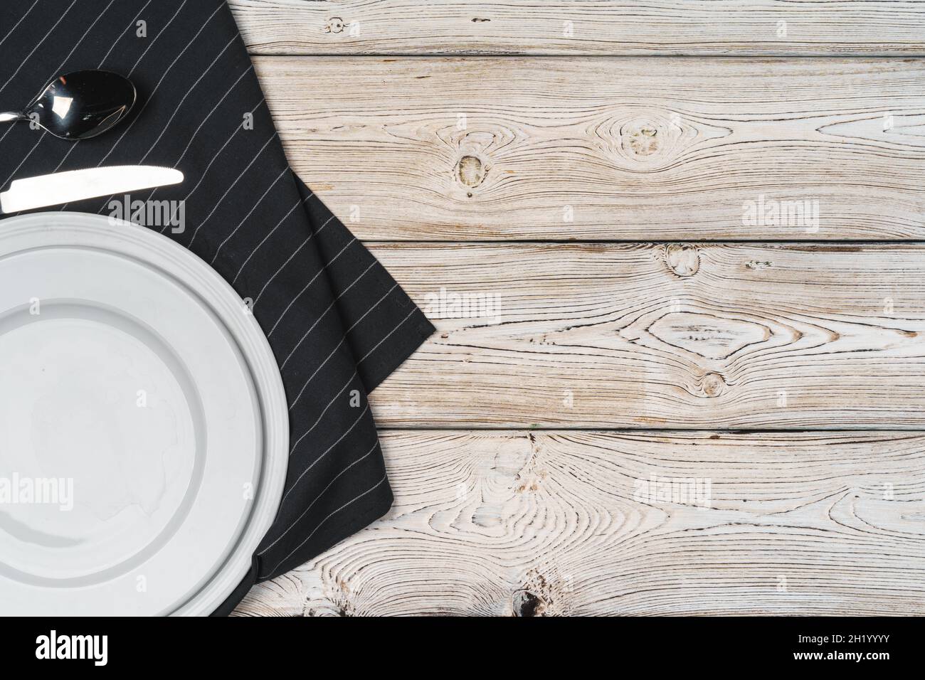 Table setup with plates on dark wooden background Stock Photo - Alamy
