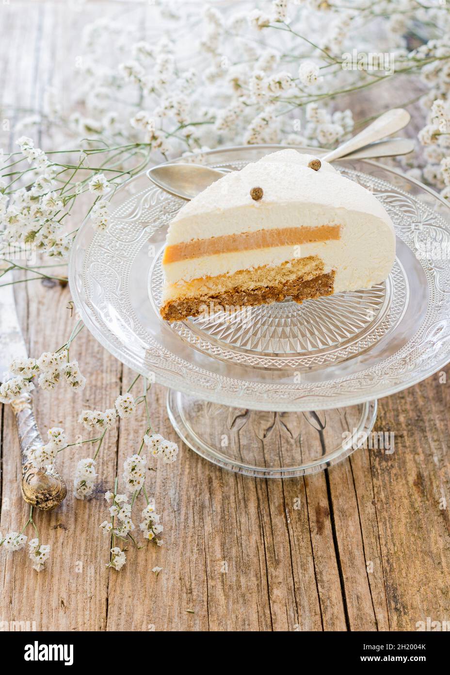 A slice of layer cake on a cake stand Stock Photo - Alamy