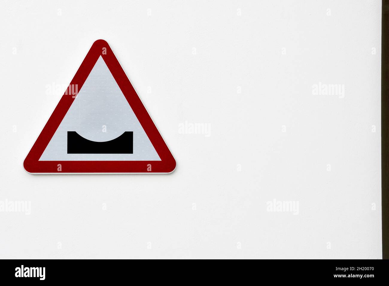 Warning sign for speed bumps, on white background Stock Photo - Alamy