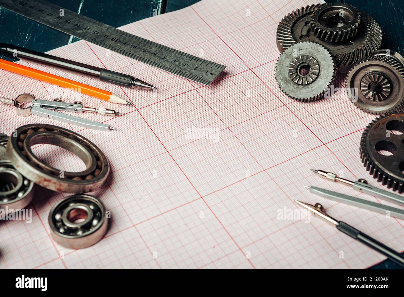 Car parts on graph paper close up. Engineering concept Stock Photo - Alamy