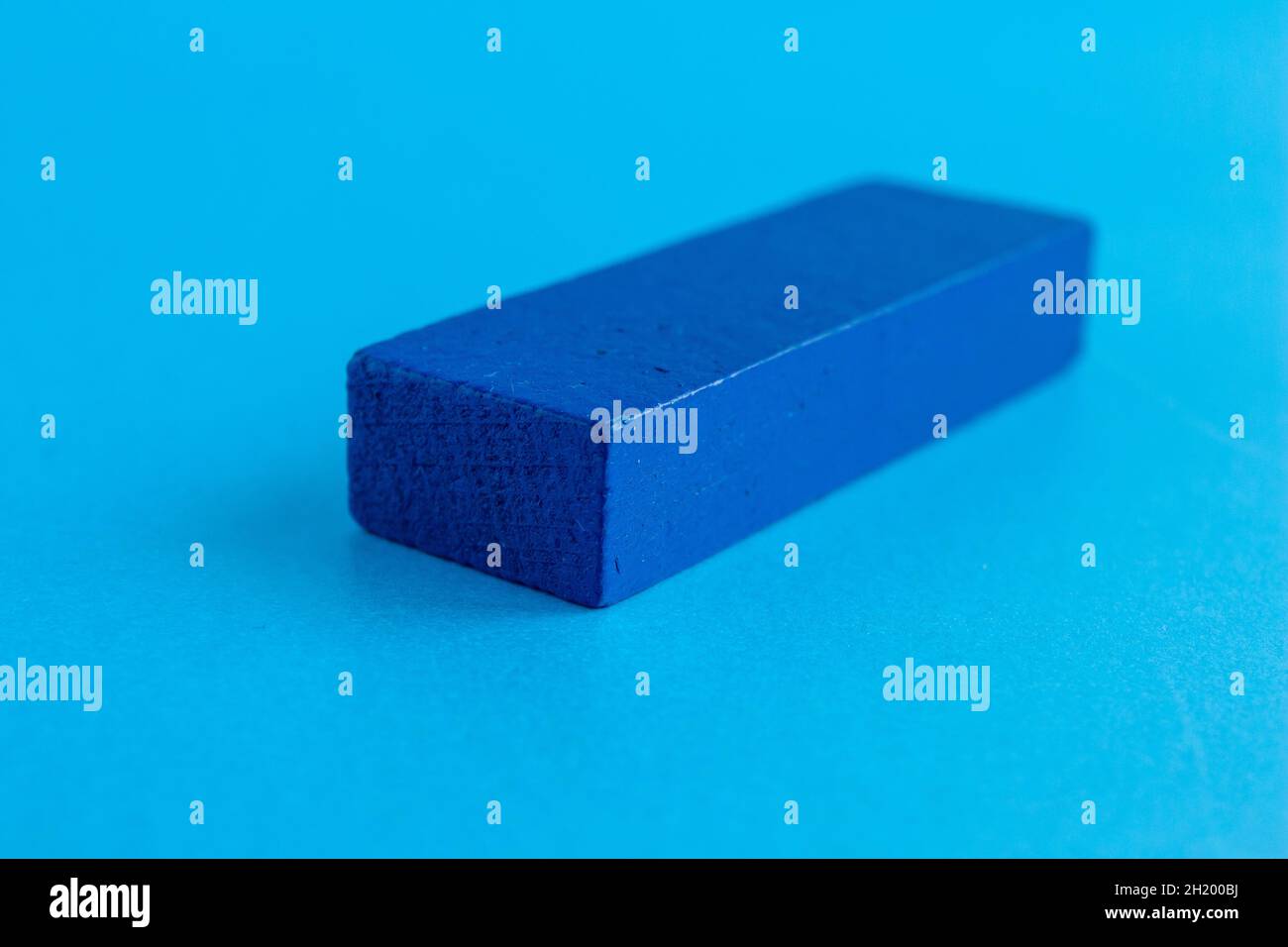 Blue wooden block, close up photo of blue wooden block isolated on blue ...