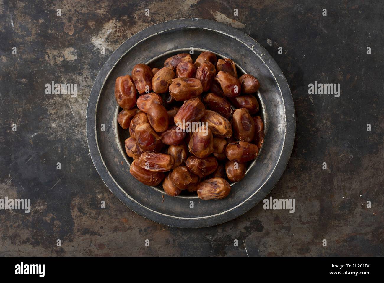 Dried dates on a metal plate Stock Photo - Alamy