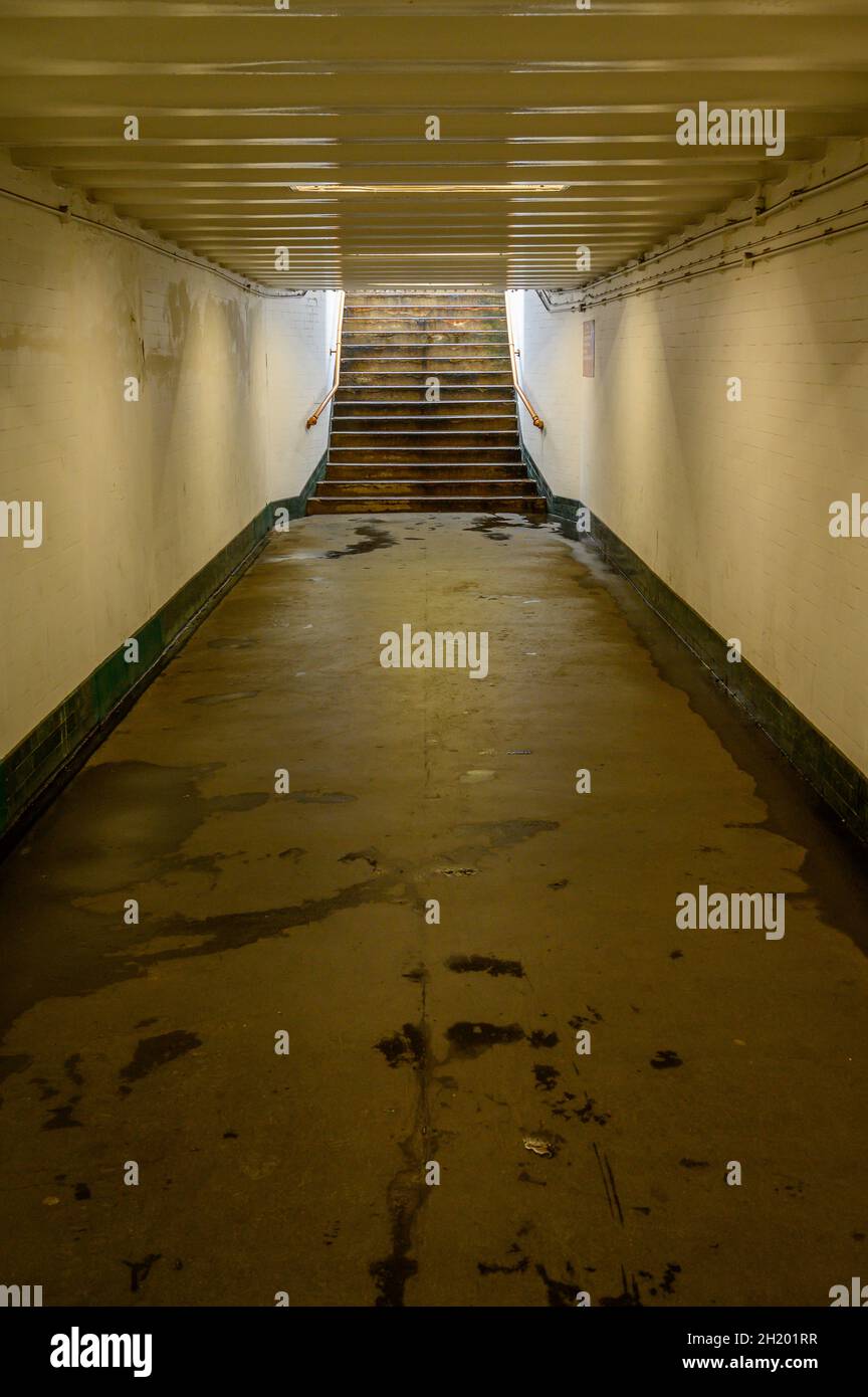 An empty subway with stairs leading up to street level near Mansion ...