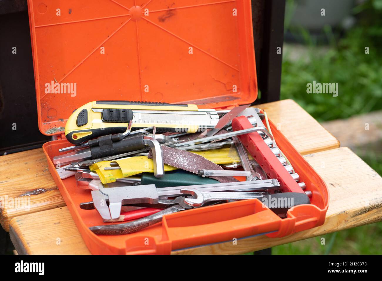 Orange plastic toolkit with instruments lies on wooden bench Stock ...