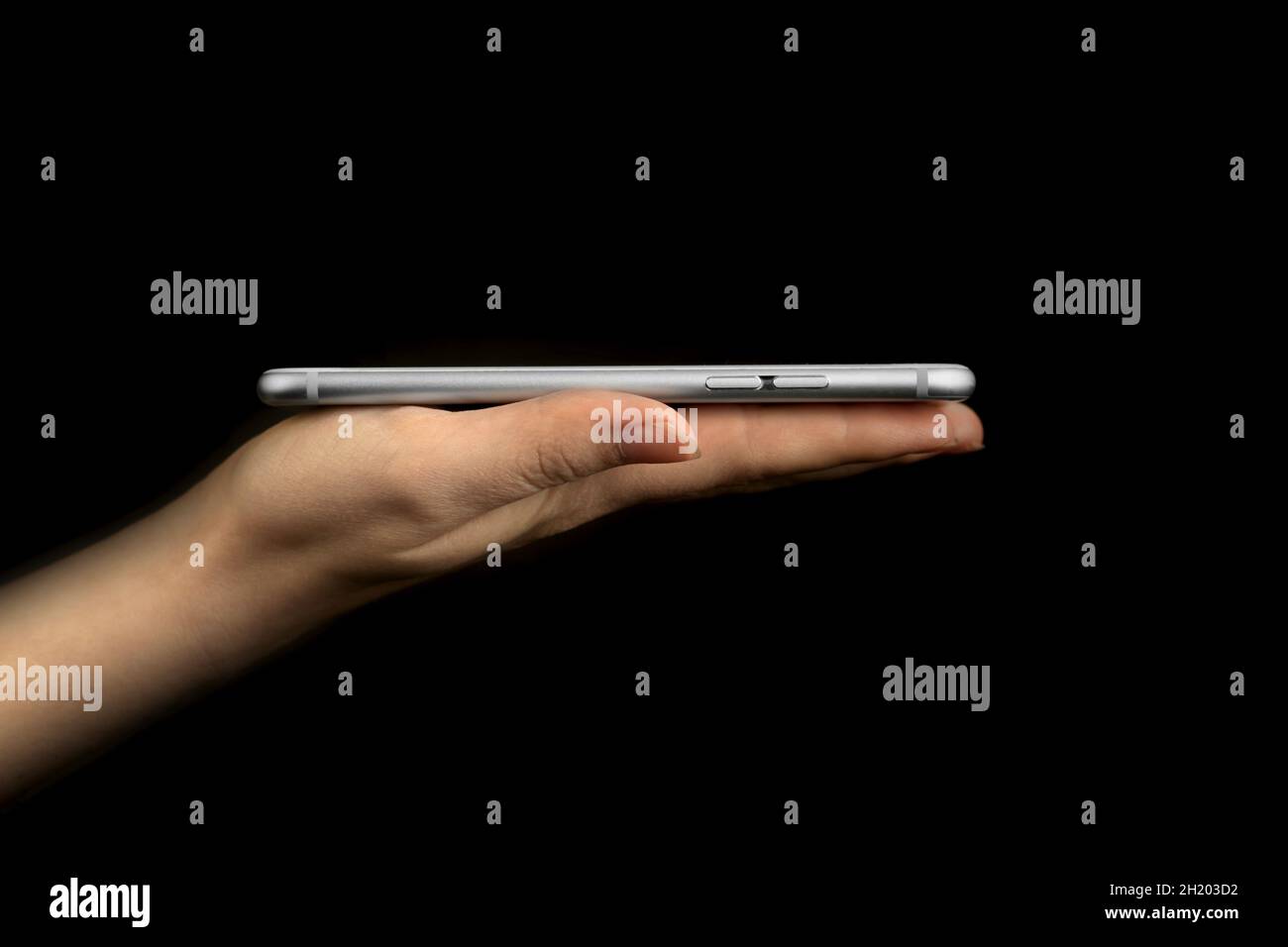 Hand holding mobile phone side view for presenation, studio shot ...