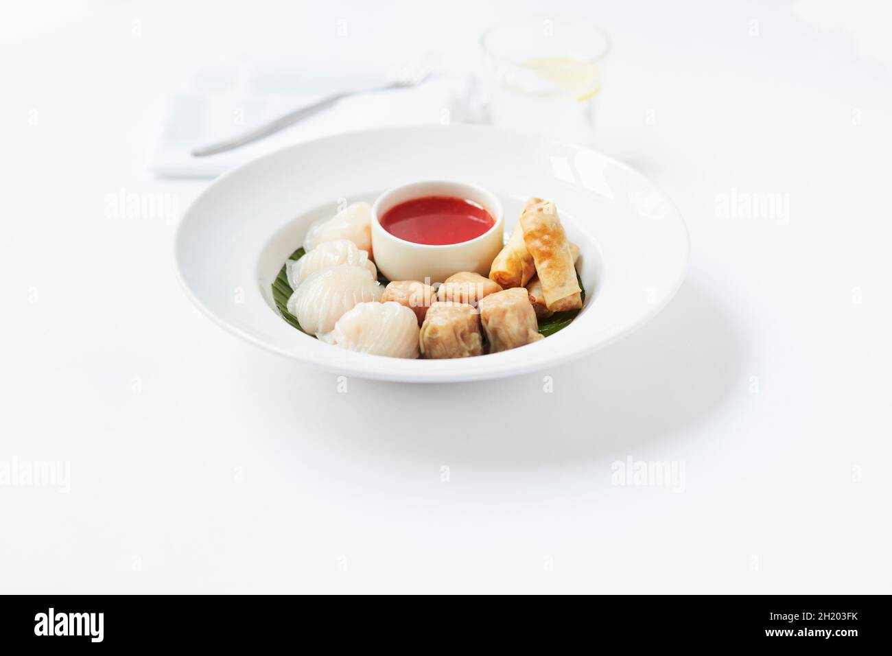Various types of dim sum on a plate with a dip Stock Photo - Alamy