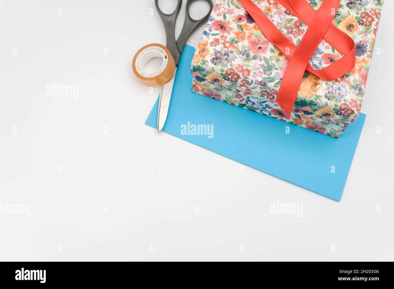 decorated box with blue letter paper ribbon and stationery on a white ...