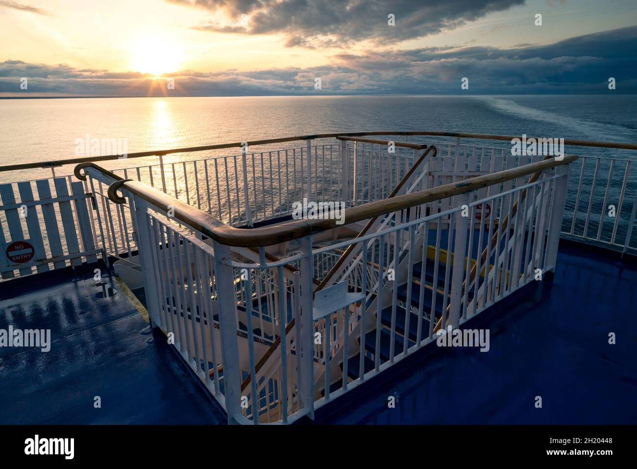 Epic sunrise on the sea viewed from the deck of a crusing ship heading ...