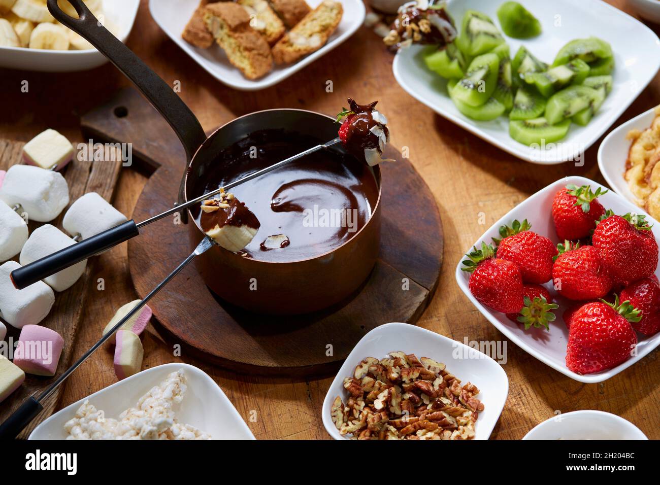 Chocolate fondue with fruit and marshmallows Stock Photo - Alamy