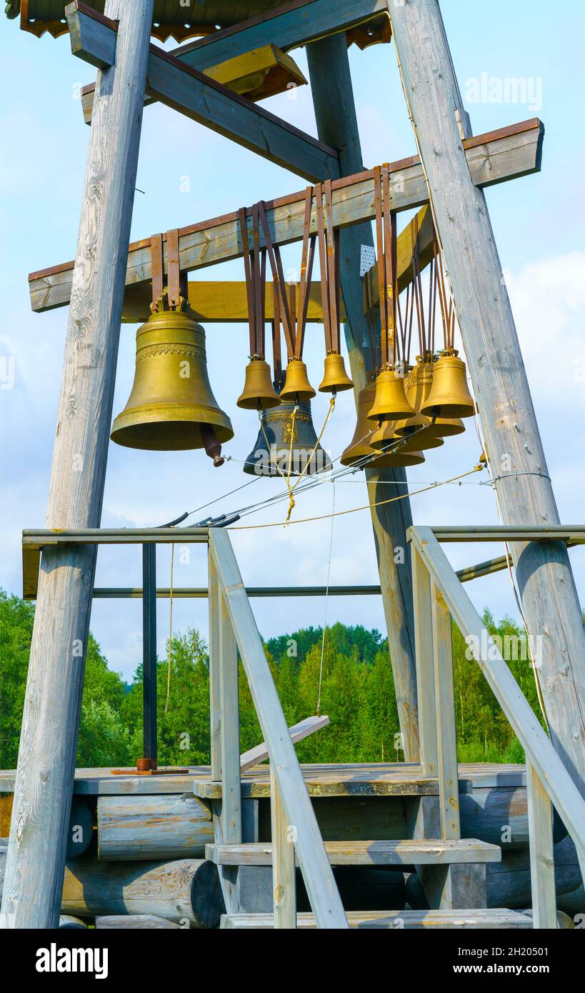 Church bells hanging in a wooden bell tower. church bellson a wooden ...