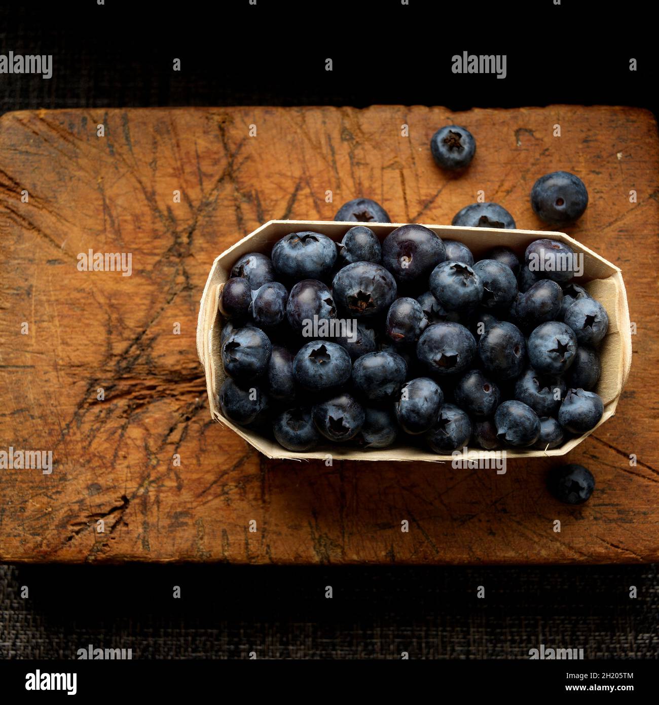 Blueberries in wooden tray on cutting board Stock Photo - Alamy